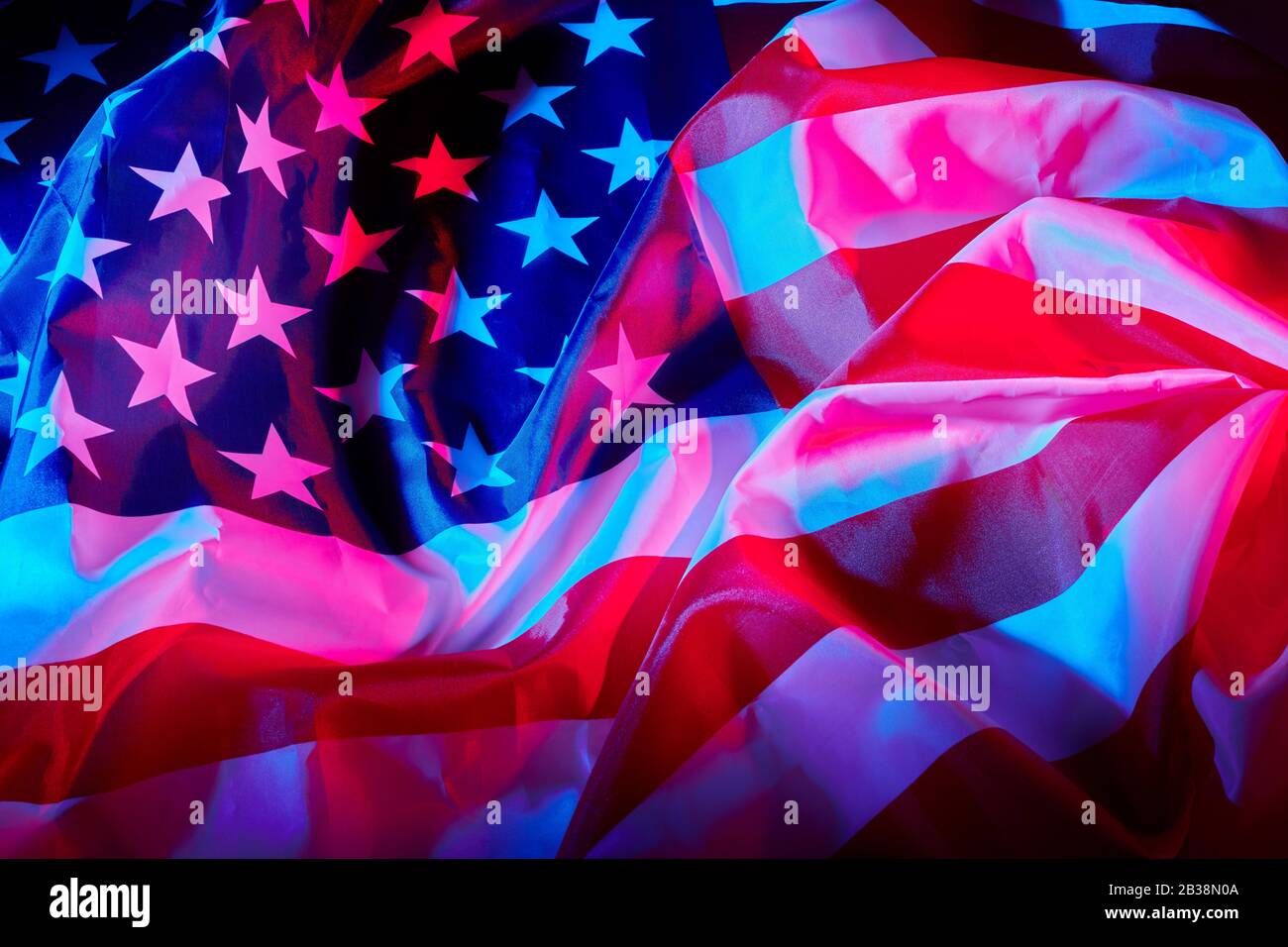 Crumpled American flag lit with blue and red lights for patriotism ...