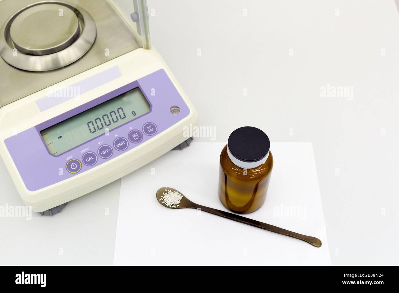 laboratory scale on table with materials in bottle Stock Photo - Alamy