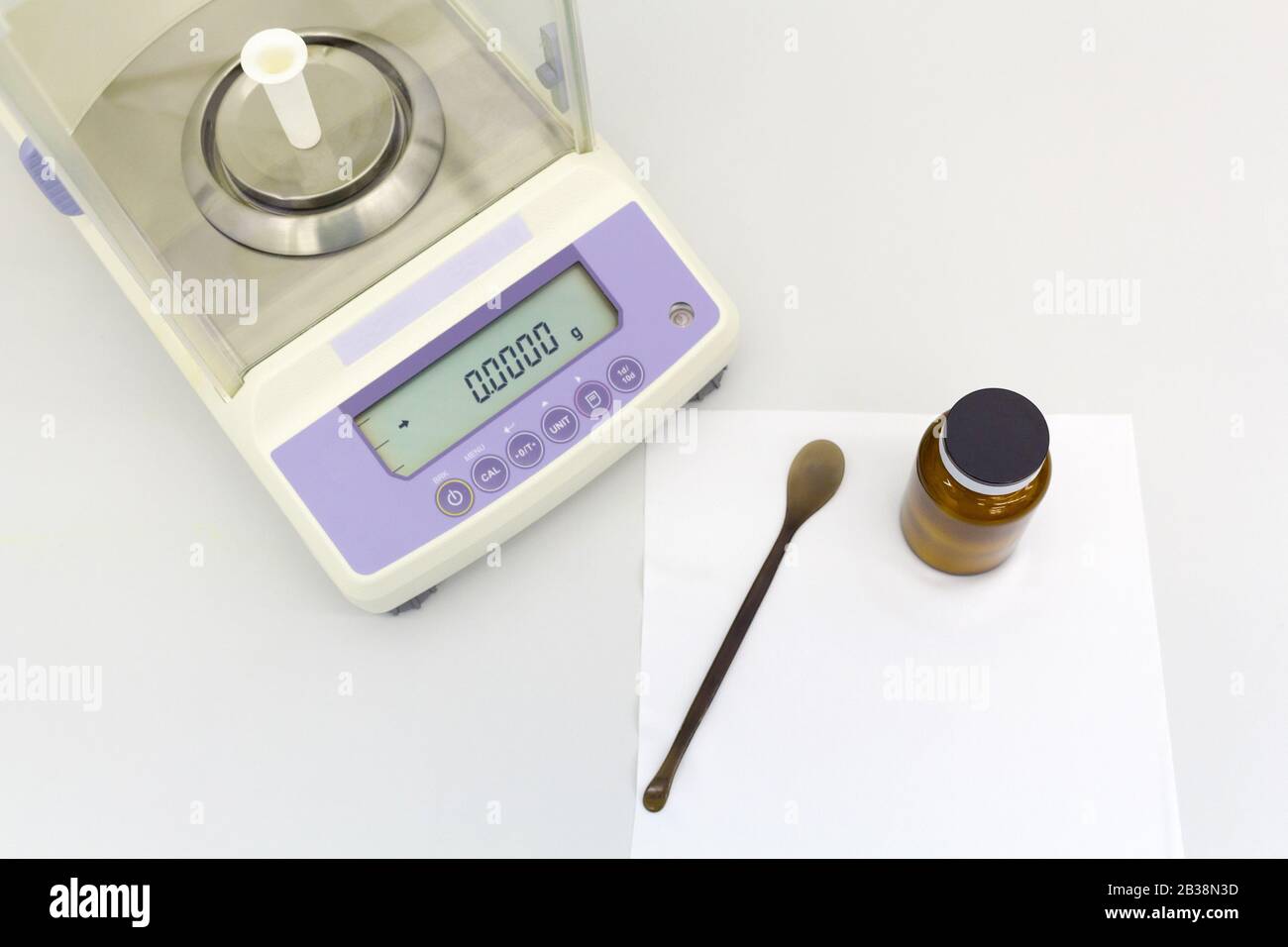 laboratory scale on table with materials in bottles Stock Photo - Alamy