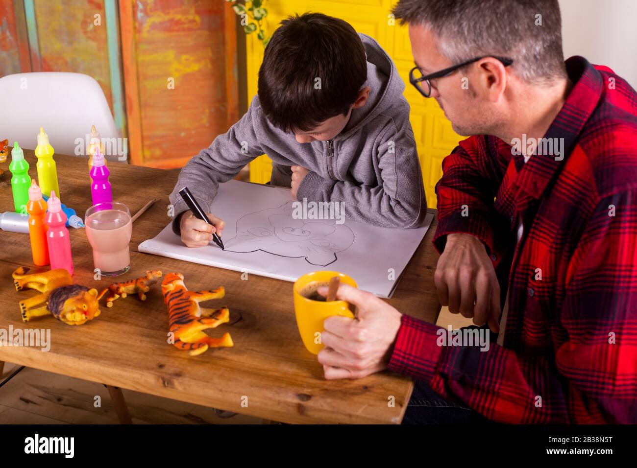 Boy drawing with his father Stock Photo - Alamy