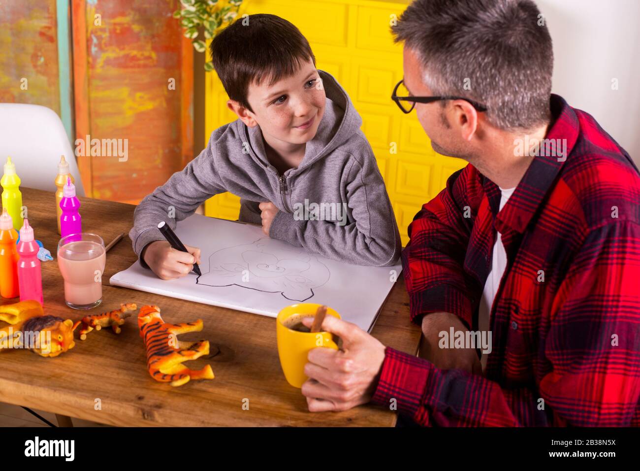 Boy drawing with his father Stock Photo - Alamy