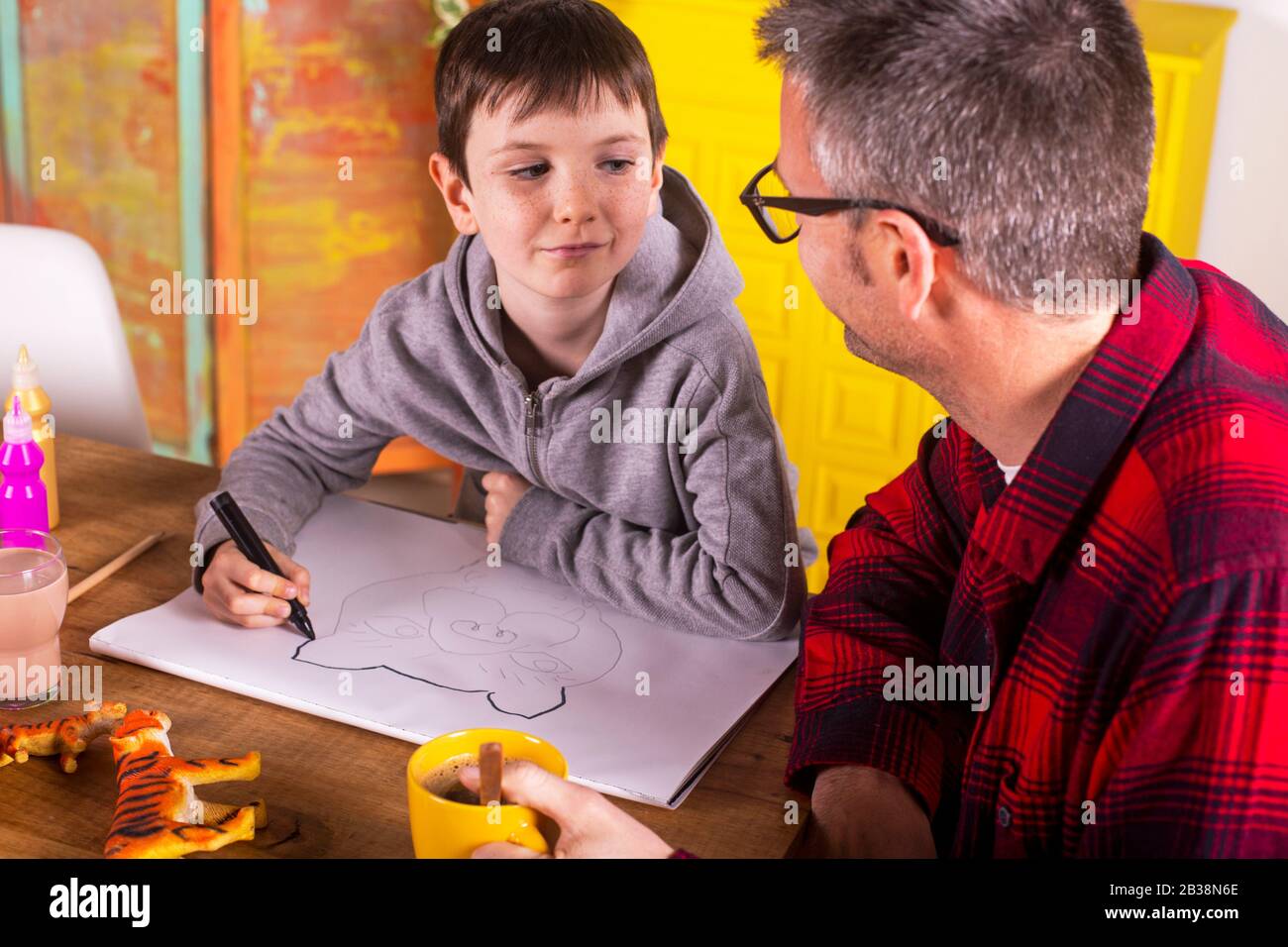 Boy drawing with his father Stock Photo - Alamy