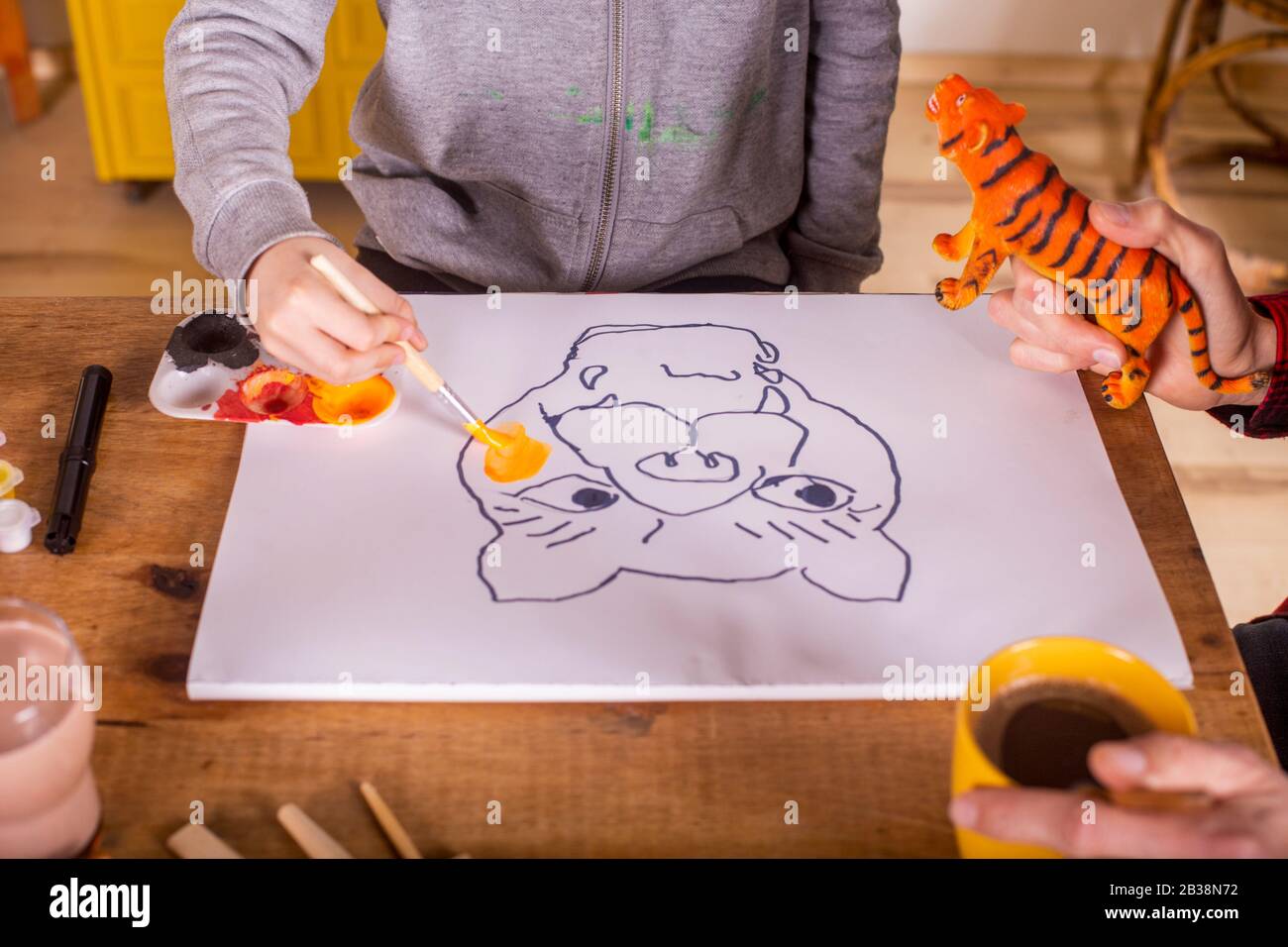 Boy painting with his father Stock Photo - Alamy