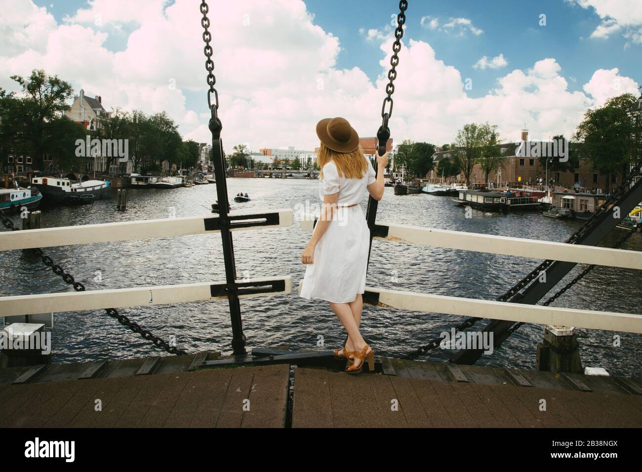 Woman on bridge overlooking city Stock Photo - Alamy