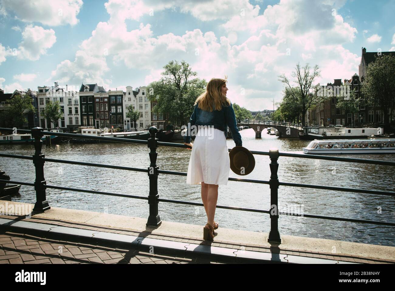 Woman in white dress overlooking city and canal Stock Photo - Alamy