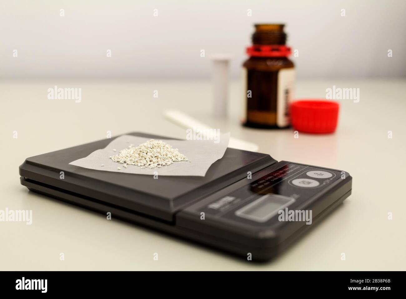 The laboratory scale of black color on table with material on surface ...