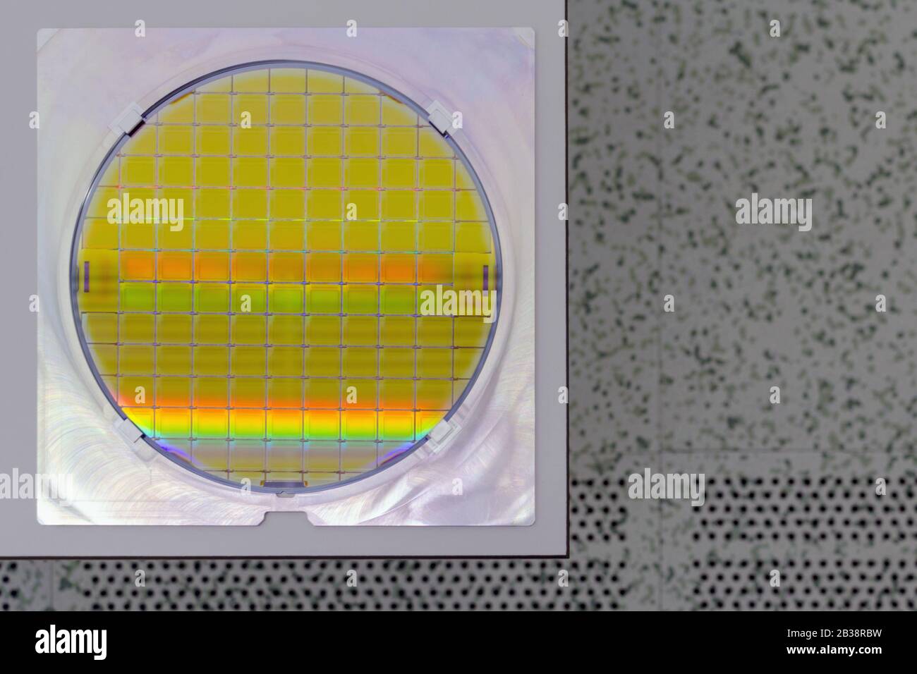 Silicon Wafer in steel holder on a table - A wafer is a thin slice of ...