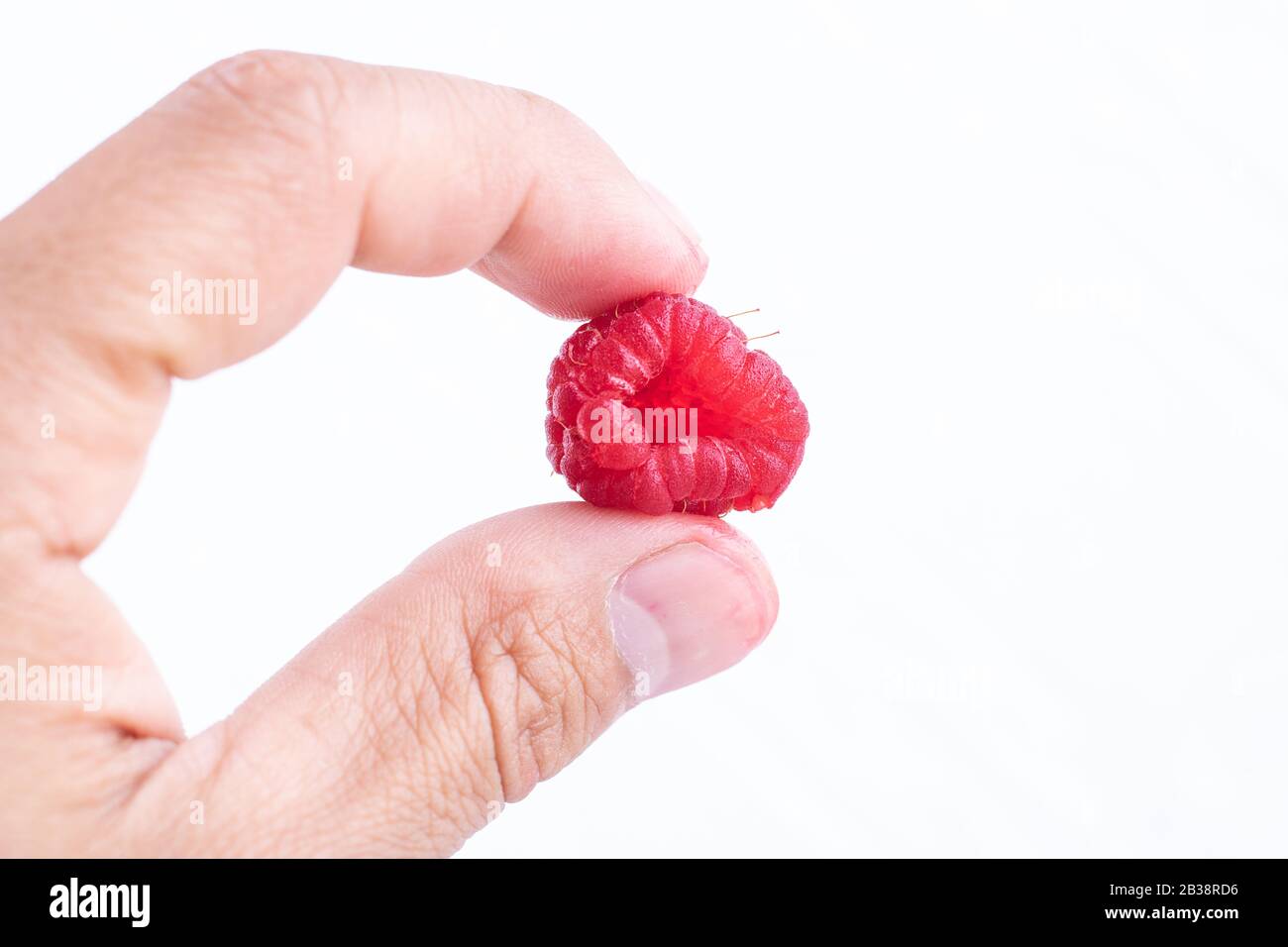 Unusual weird shape ripe red strawberry in hand, non commercialized ...