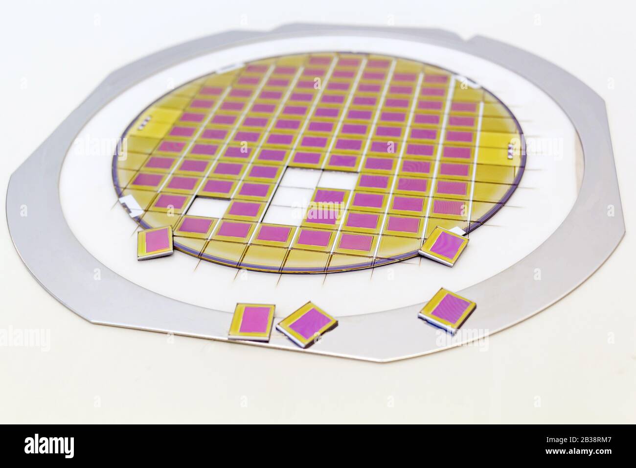 Silicon wafer with microchips fixed in a holder with a steel frame ...