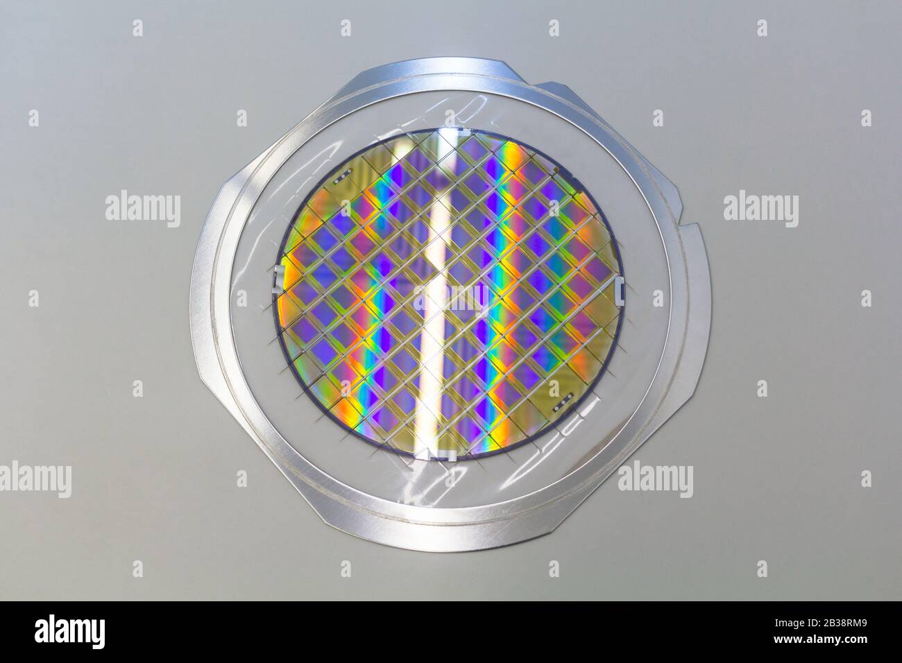 Silicon wafer with microchips fixed in the holder with steel frame on ...