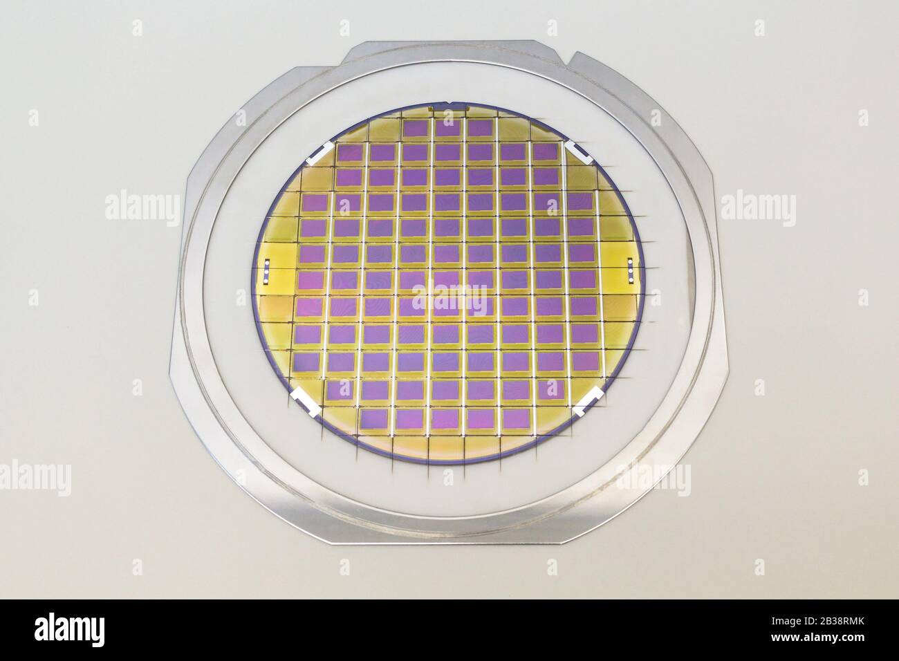Silicon wafer with microchips fixed in the holder with steel frame on ...
