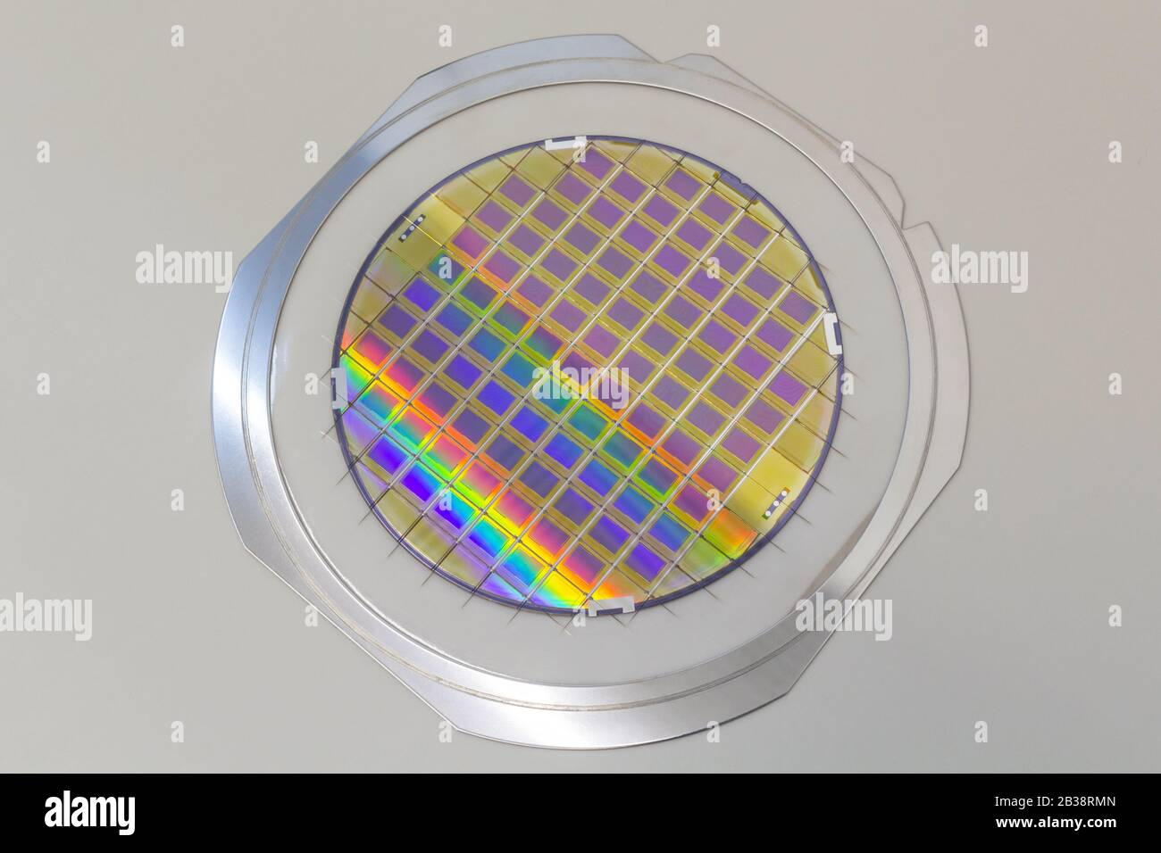 Silicon wafer with microchips fixed in the holder with steel frame on ...