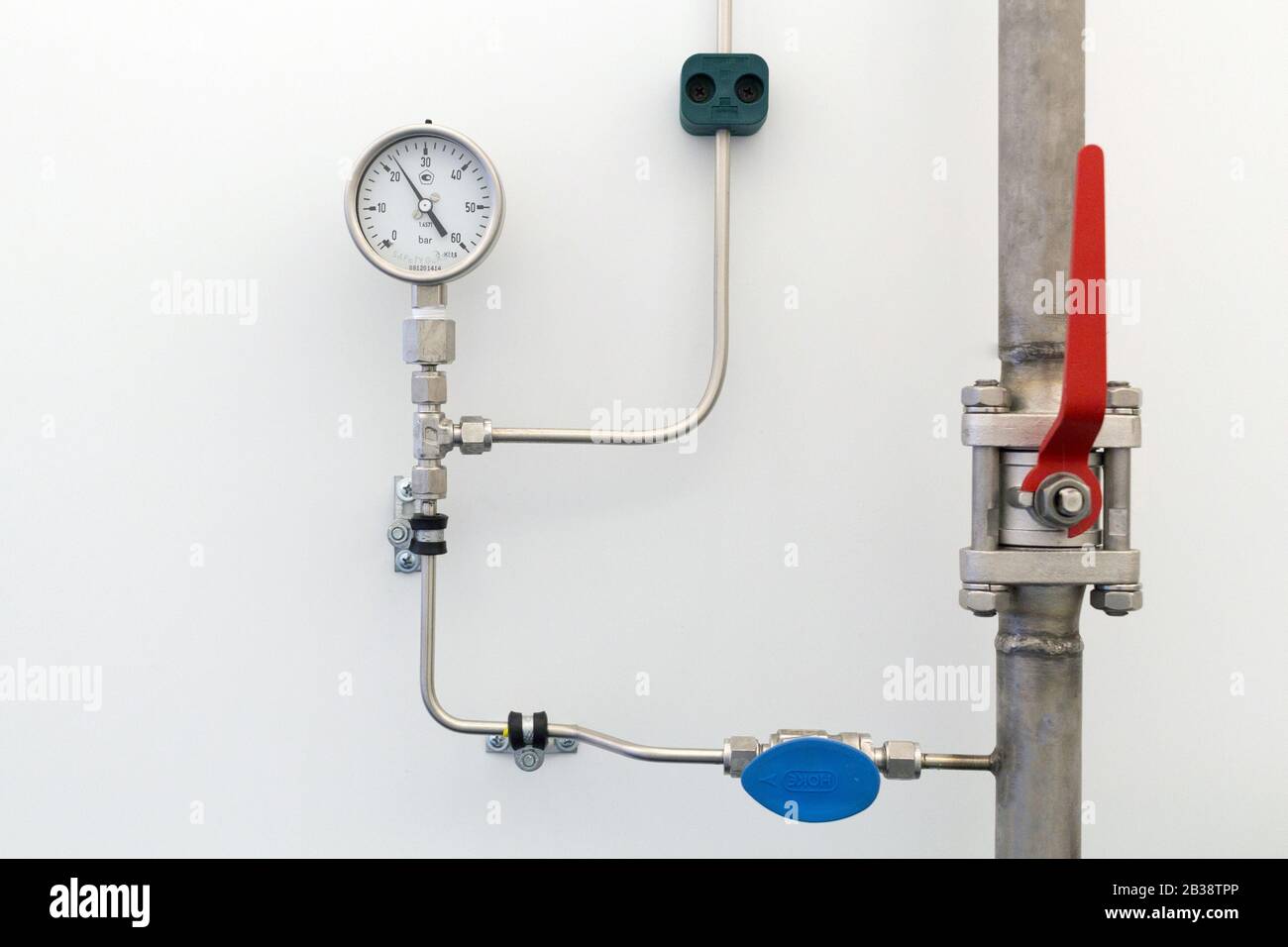 steel gas pipes with valves and manometer high pressure on the wall ...