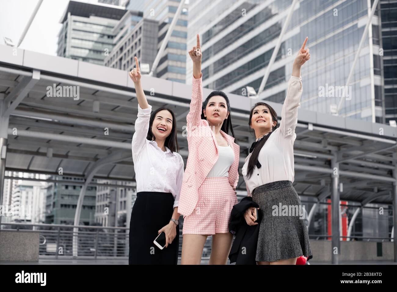 Group of asian business woman pointing forward with a smile in the ...
