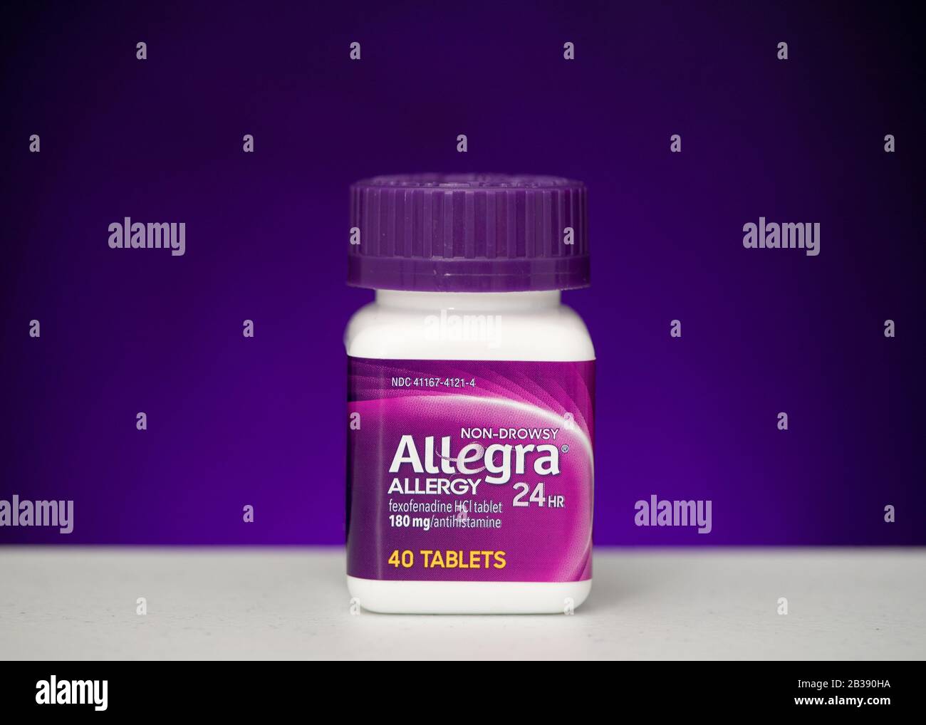 Bottle of Allegra against purple background, centered, front view ...