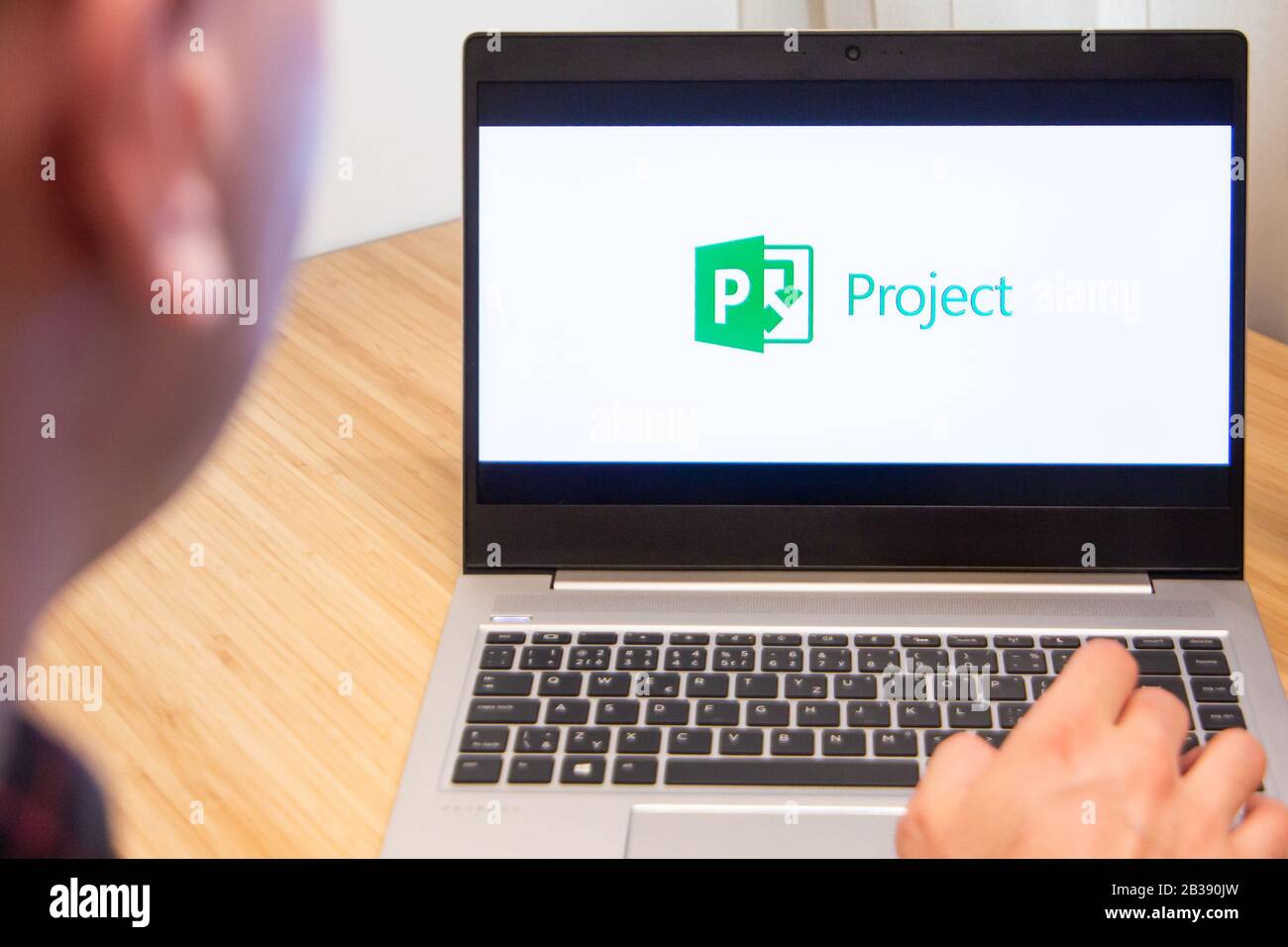Microsoft project is used by a man on the laptop. Microsoft customer ...