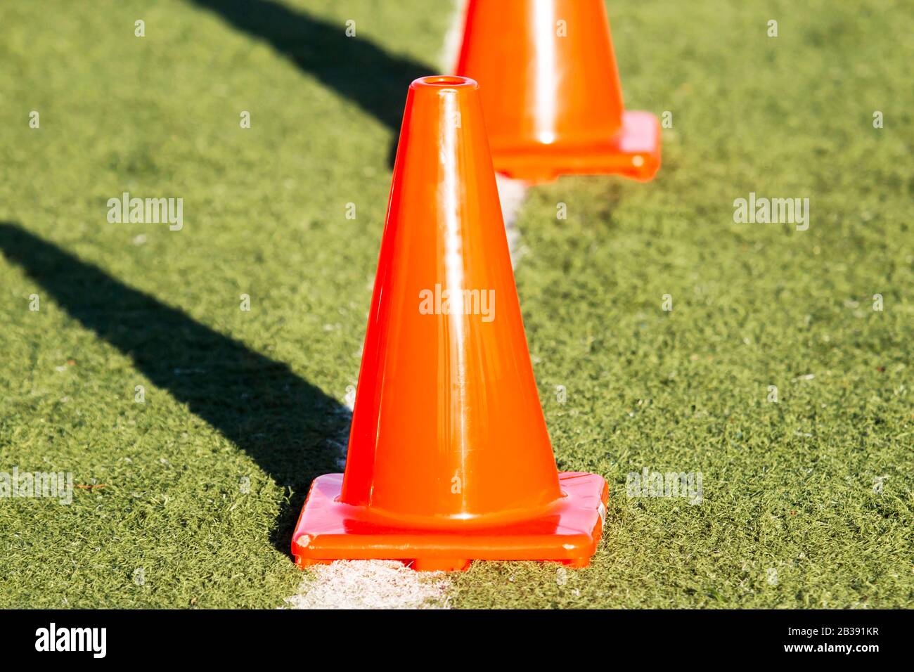 Orange cones on a green turf field up close Stock Photo - Alamy