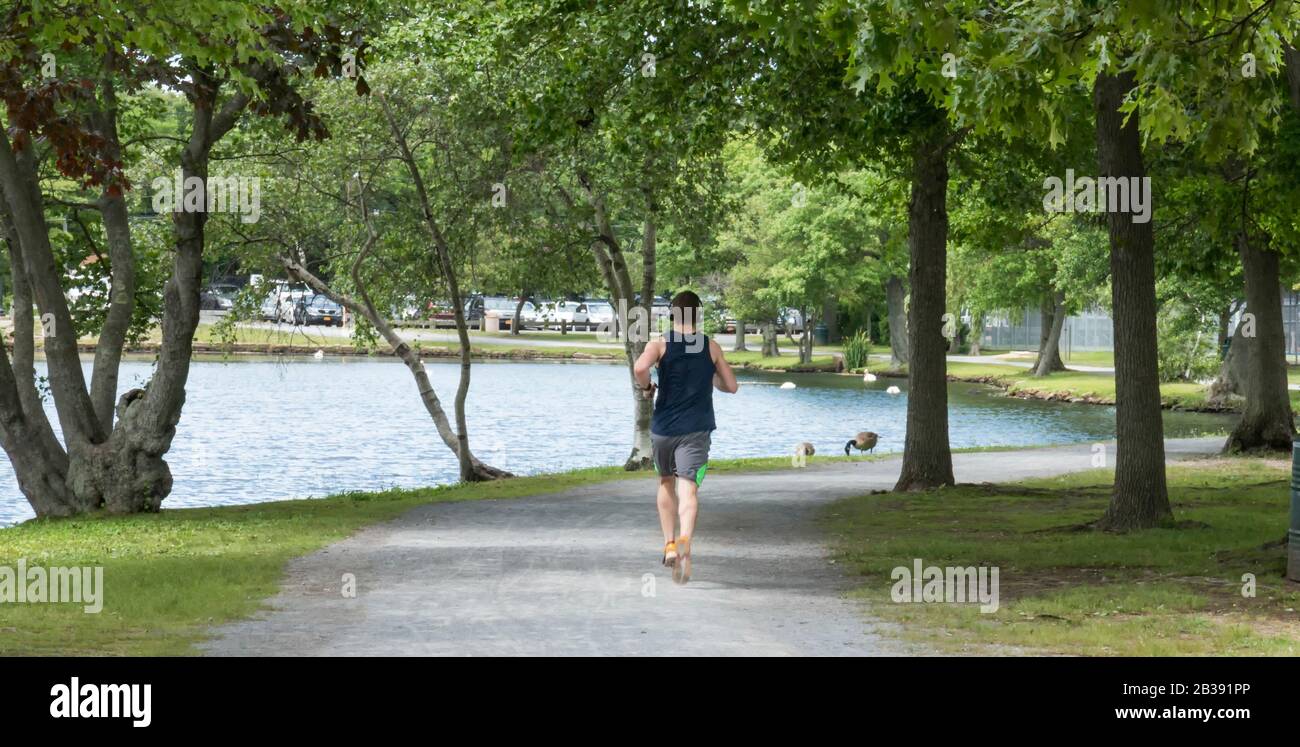 Male training cross country lake hi-res stock photography and images ...