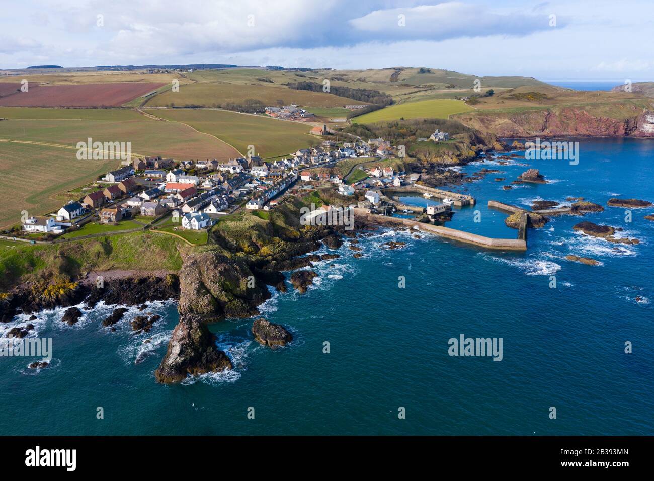 Aerial view of small fishing village and harbour of St Abbs on North ...