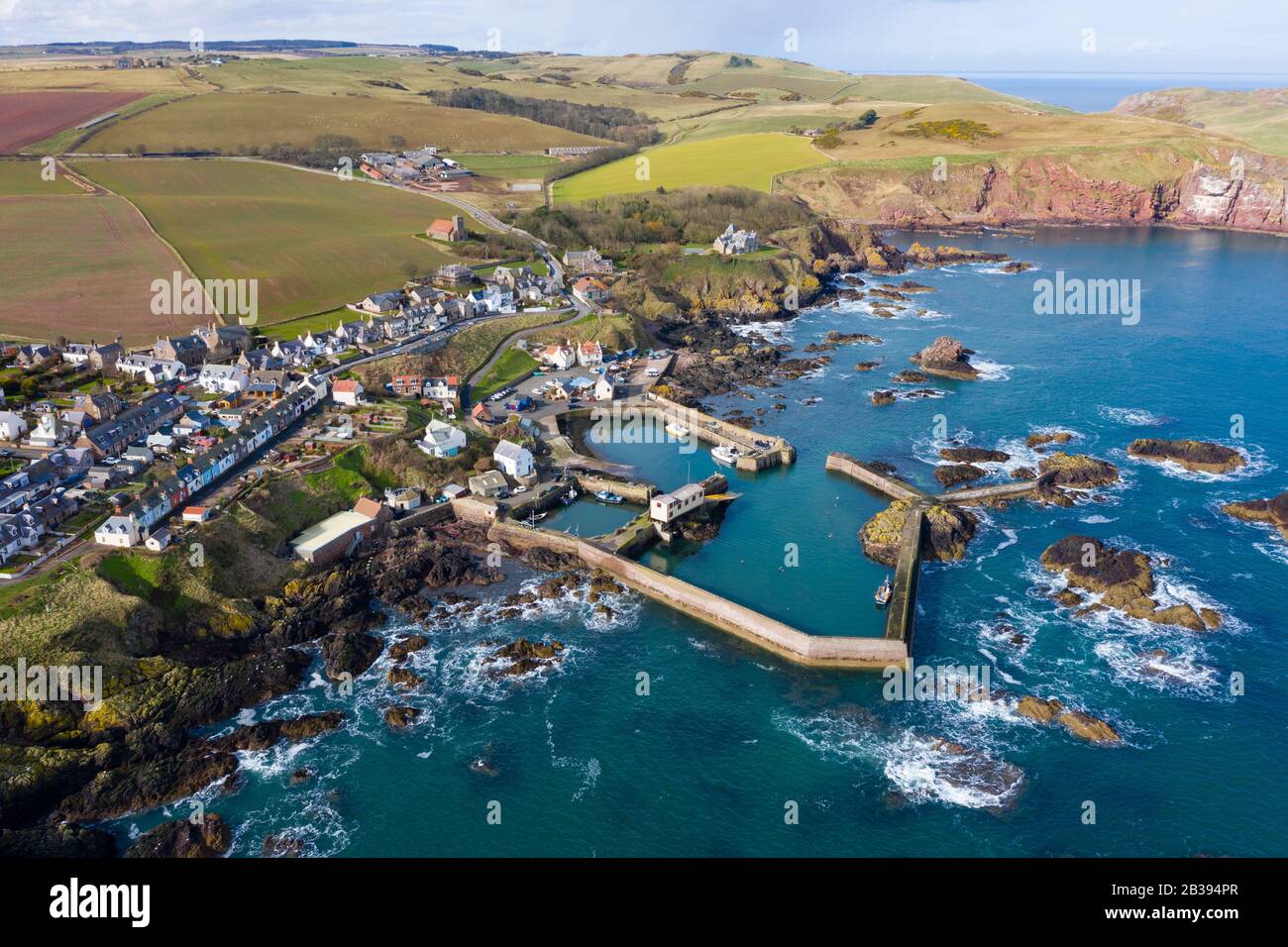 Aerial view of small fishing village and harbour of St Abbs on North ...