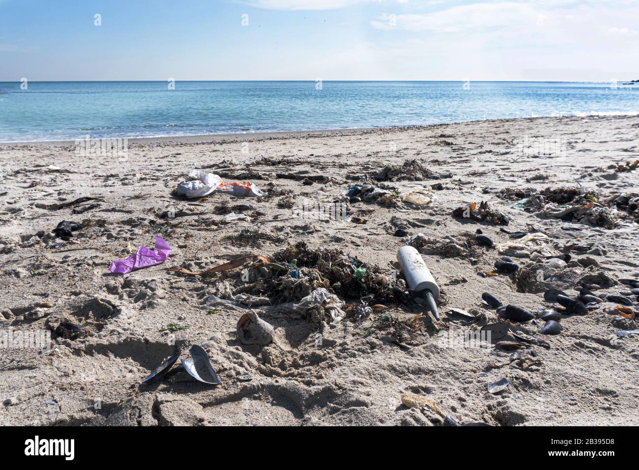 Trash at the beach near sea or ocean Stock Photo - Alamy