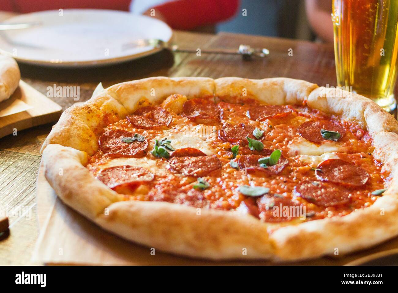 Delicious pizza served on wooden table pizza in restaurant Stock Photo ...