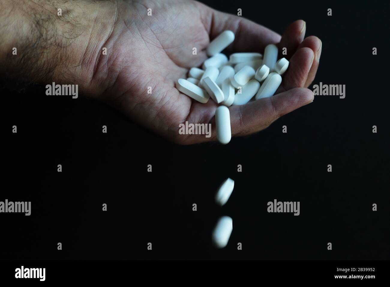 Medicine pills being thrown out by hand Stock Photo - Alamy