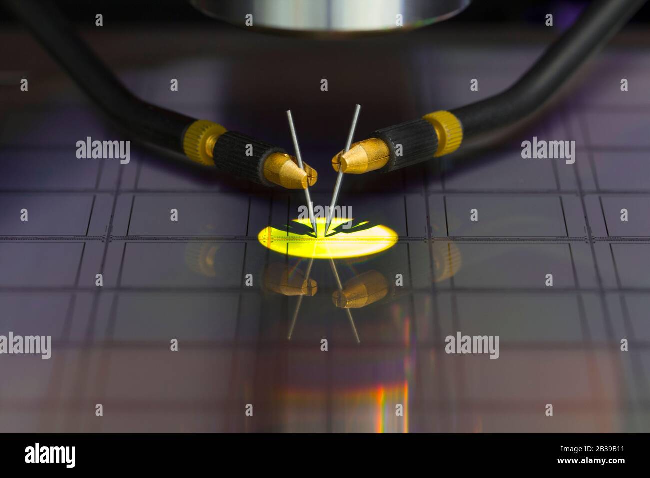 Close up of examining a sample of microchip transistor with probe ...