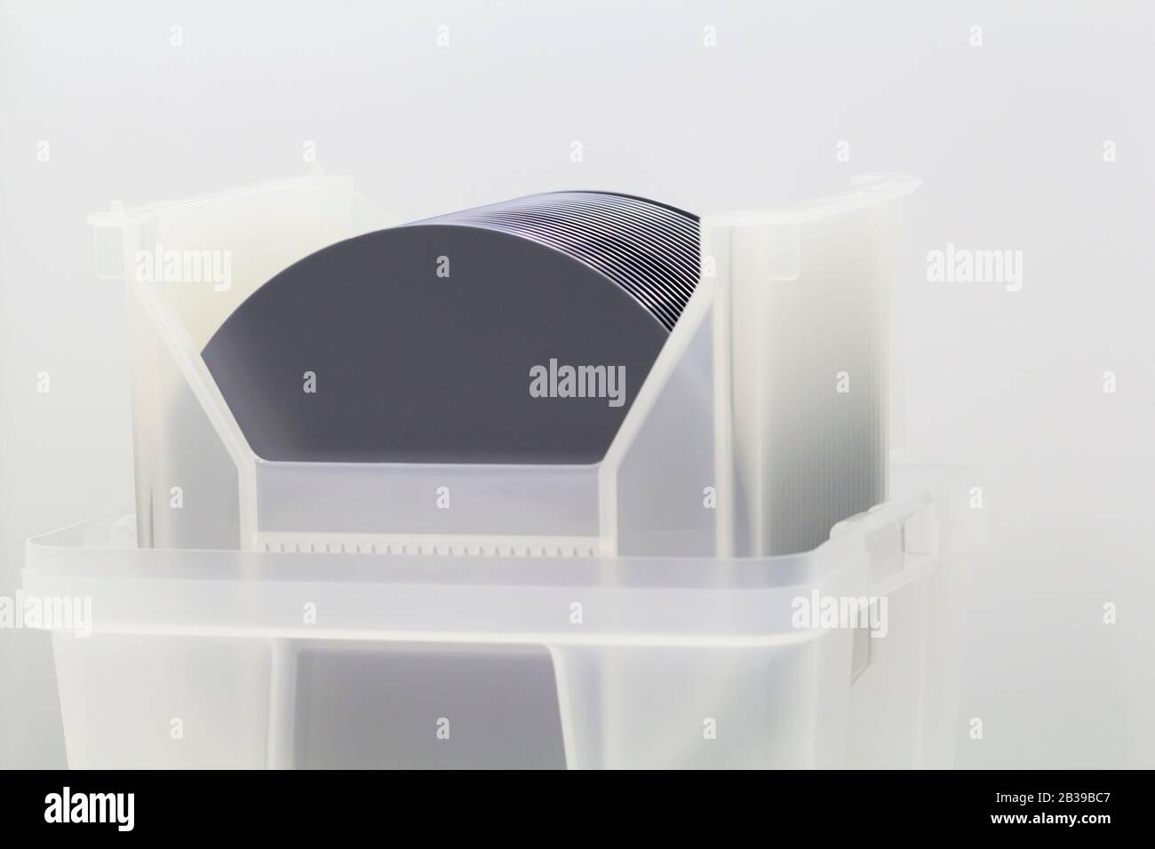 Silicon Wafers in white plastic holder box on a table- A wafer is a ...