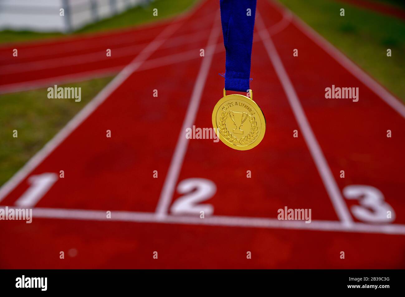 Sport inspiration, concept photo, Gold medal, red running track in ...