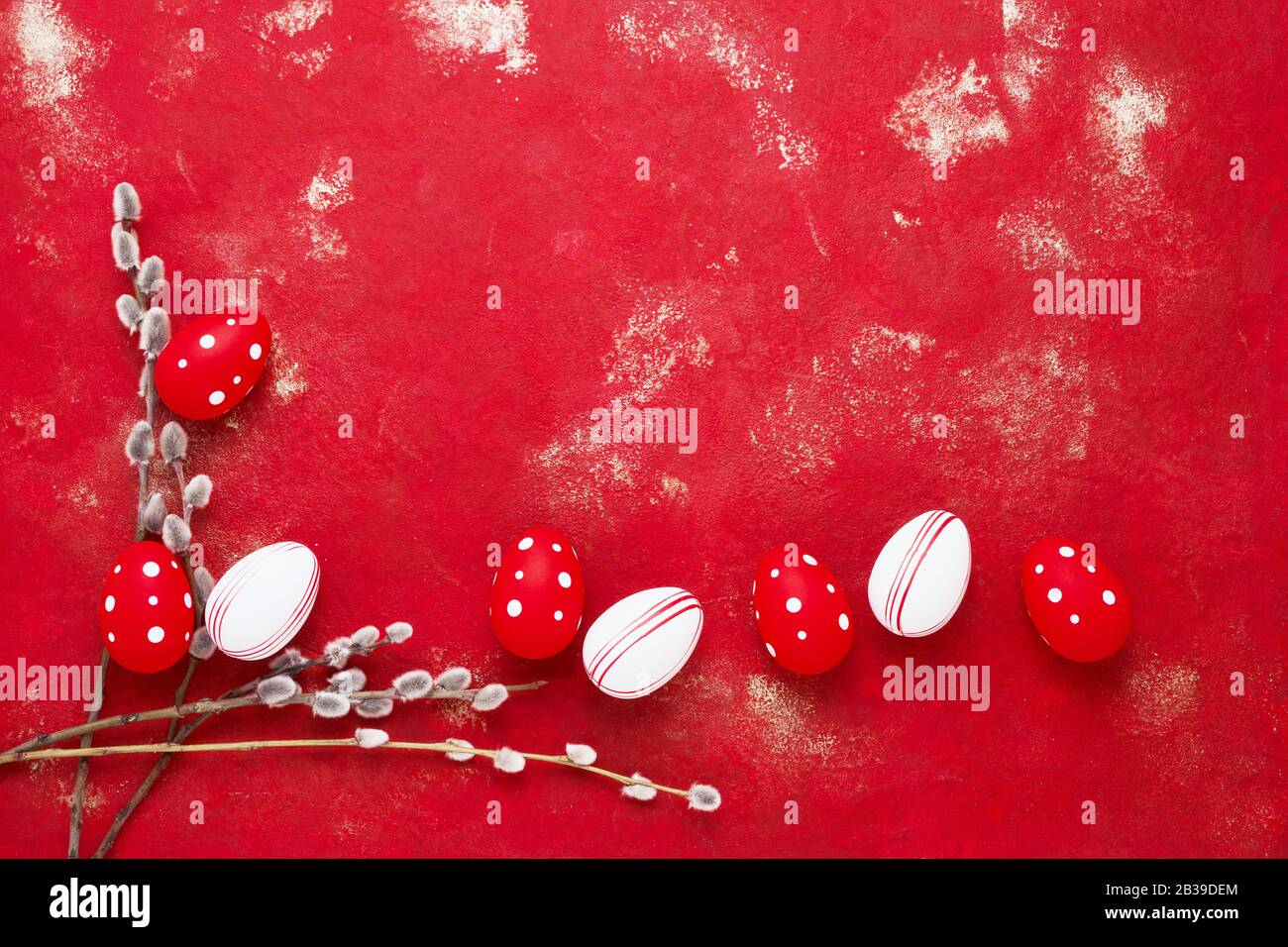 Red Easter background. Red and white Easter eggs and willow branches on ...