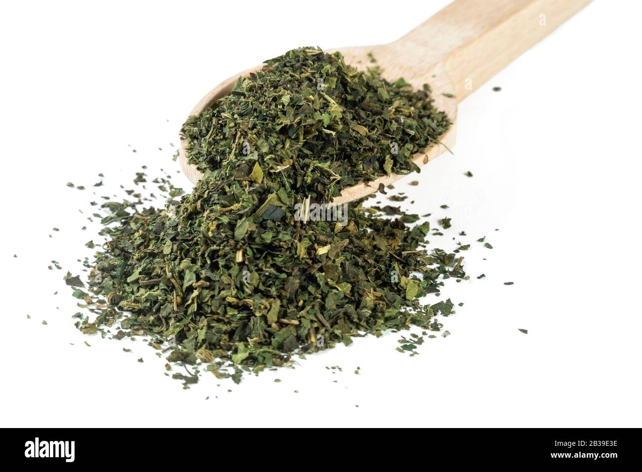 dried nettle herb or in latin Utricae folium in wooden spoon isolated ...