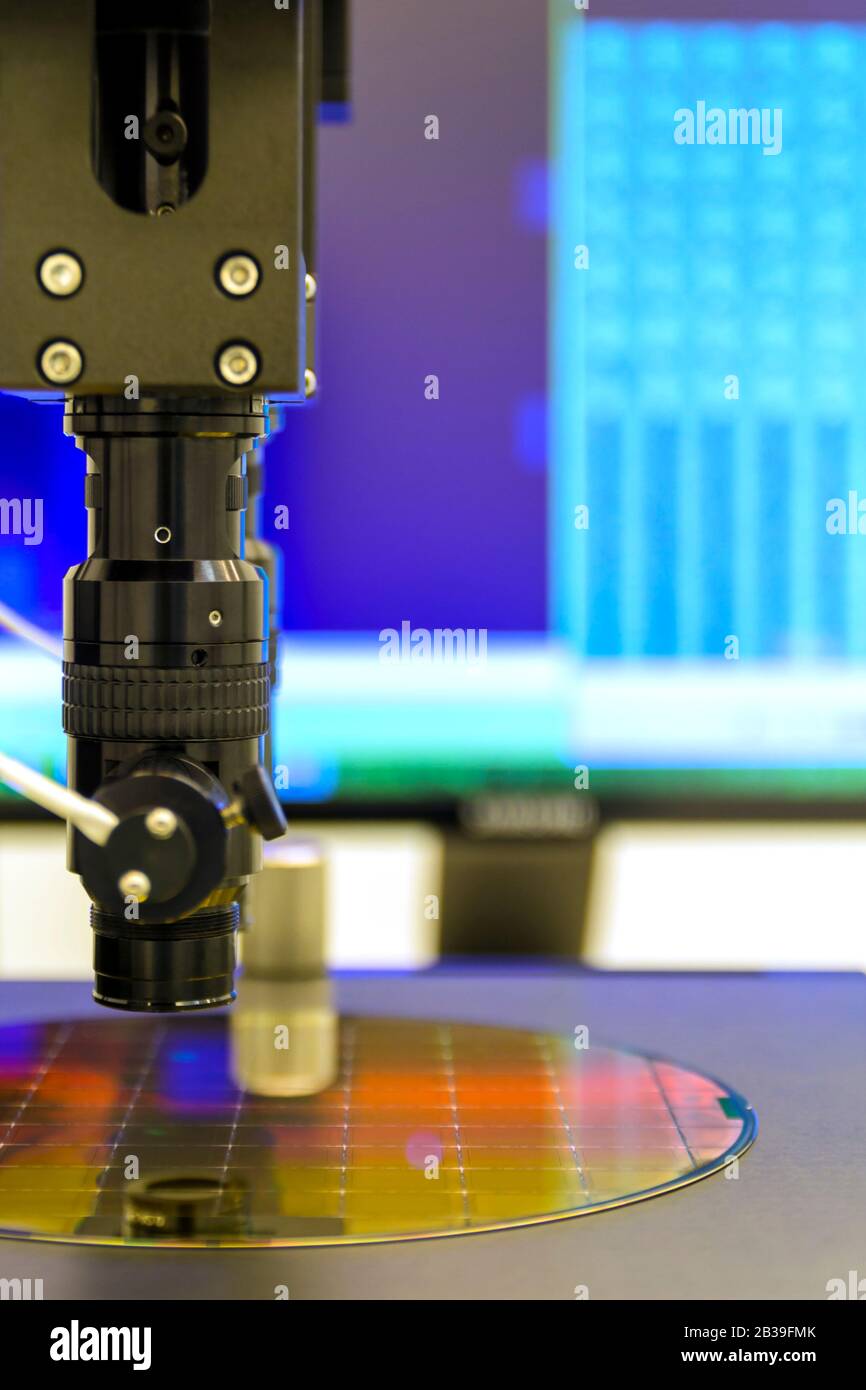 Silicon wafer with semiconductor microchip on machine process examining ...