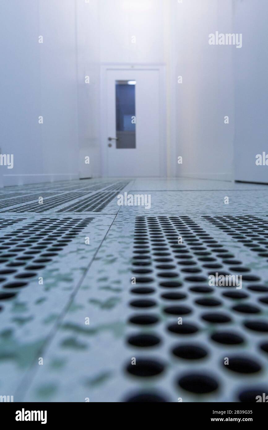 Inside white sterile cleanroom .Hallway with raised floor and door in ...