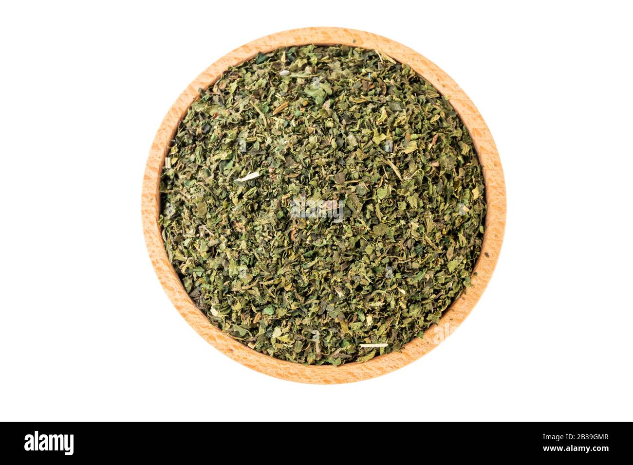 dried nettle herb or in latin Utricae folium in wooden bowl isolated on ...