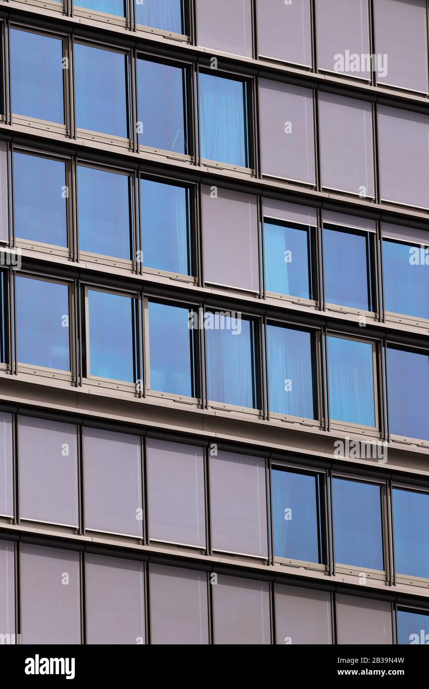 Multiple windows on a large apartment building Stock Photo - Alamy