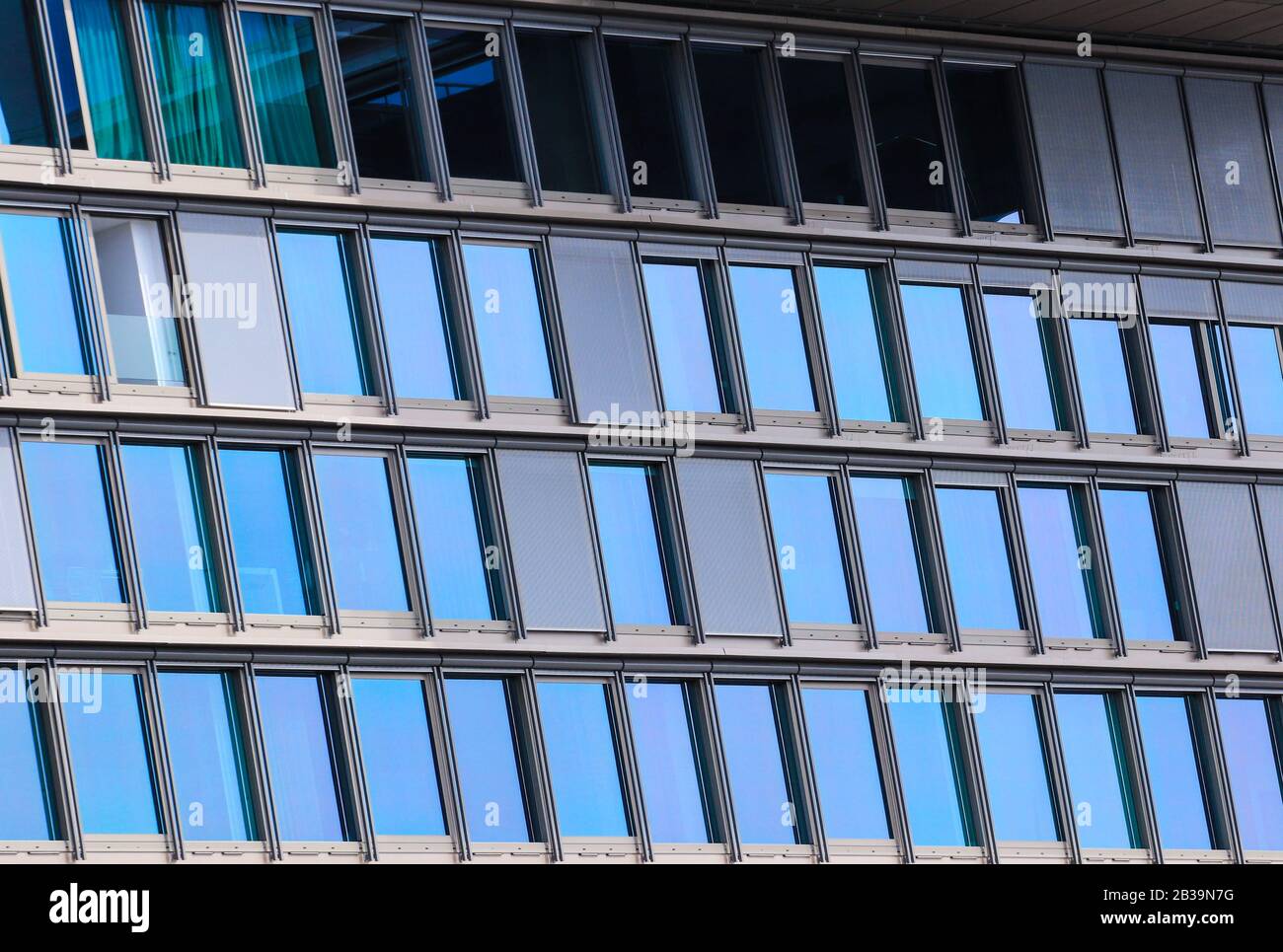 Multiple windows on a large apartment building Stock Photo - Alamy