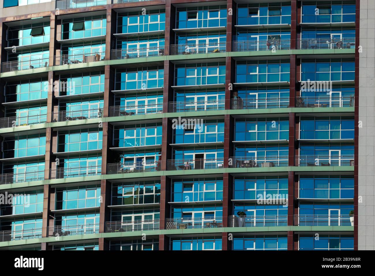 Multiple windows on a large apartment building Stock Photo - Alamy