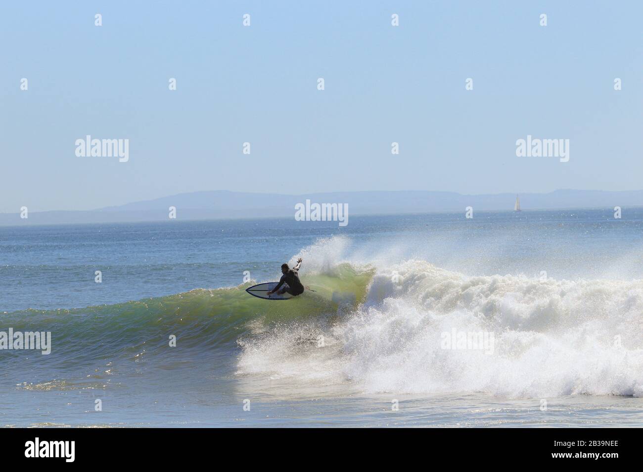 Surfer on Blue Ocean Wave Stock Photo - Alamy