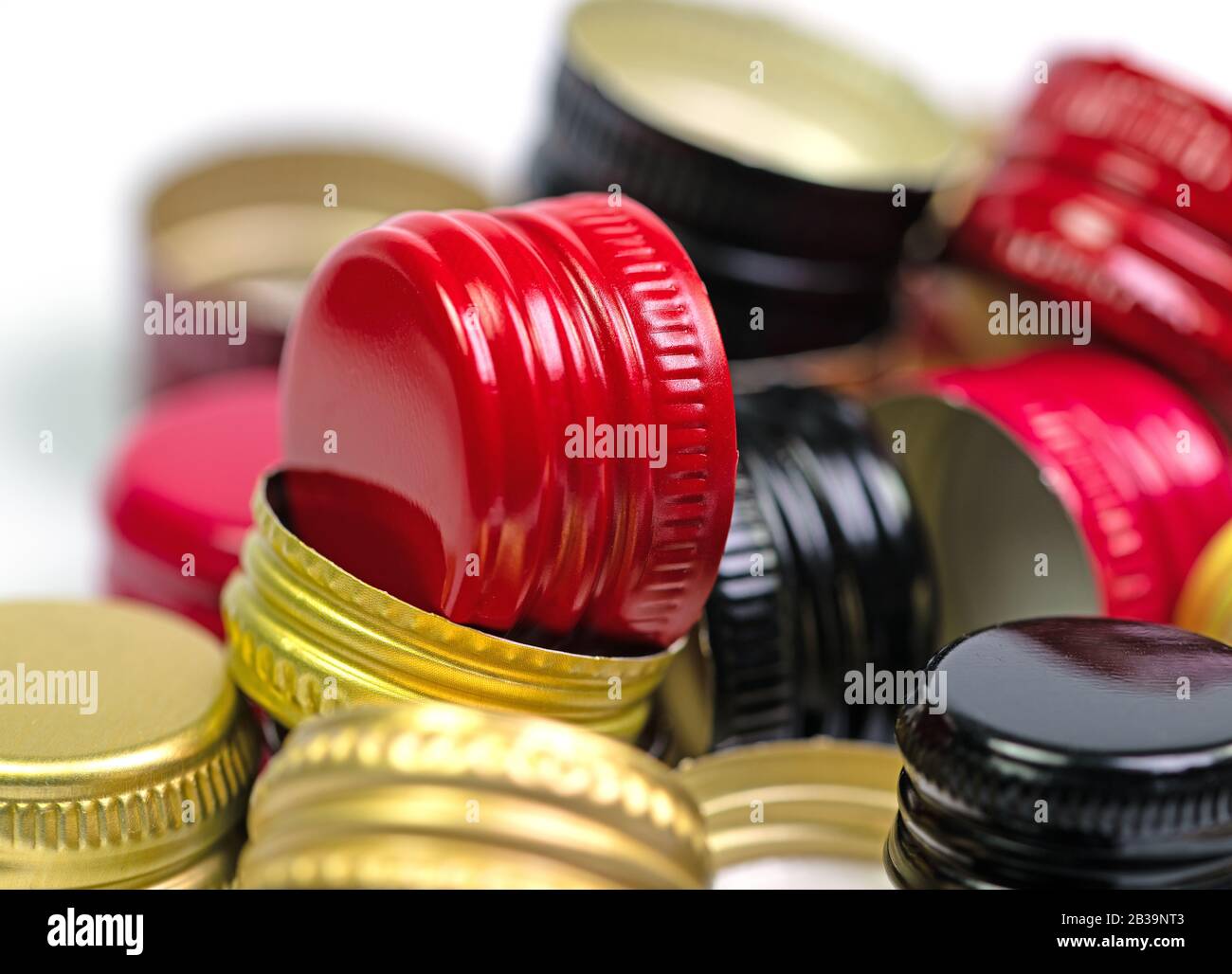 Old aluminum bottle caps against a white background Stock Photo - Alamy