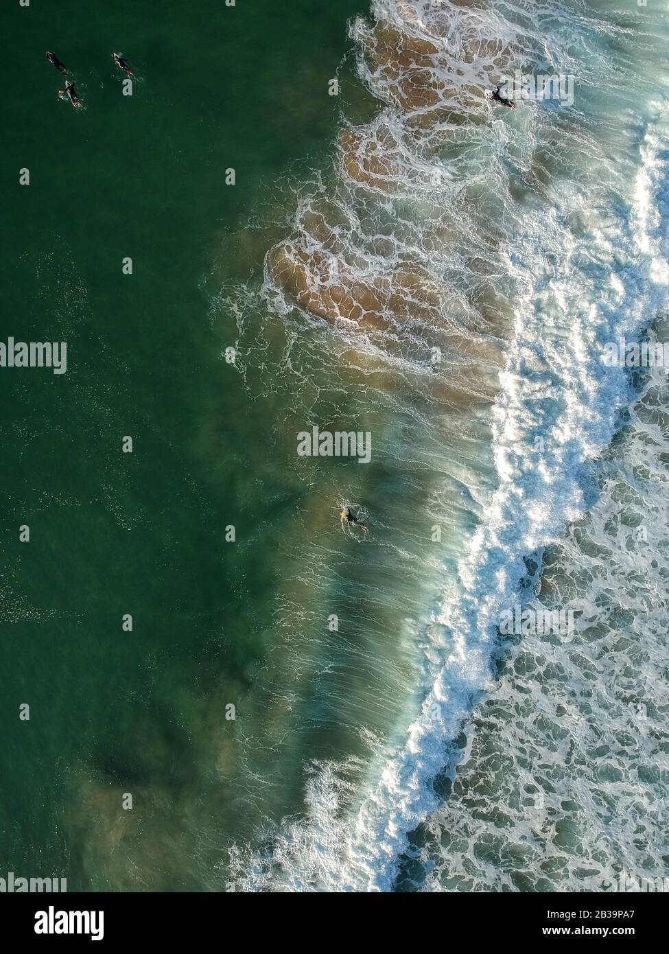 Aerial view of surfers and big wave in the ocean. Top view Stock Photo ...