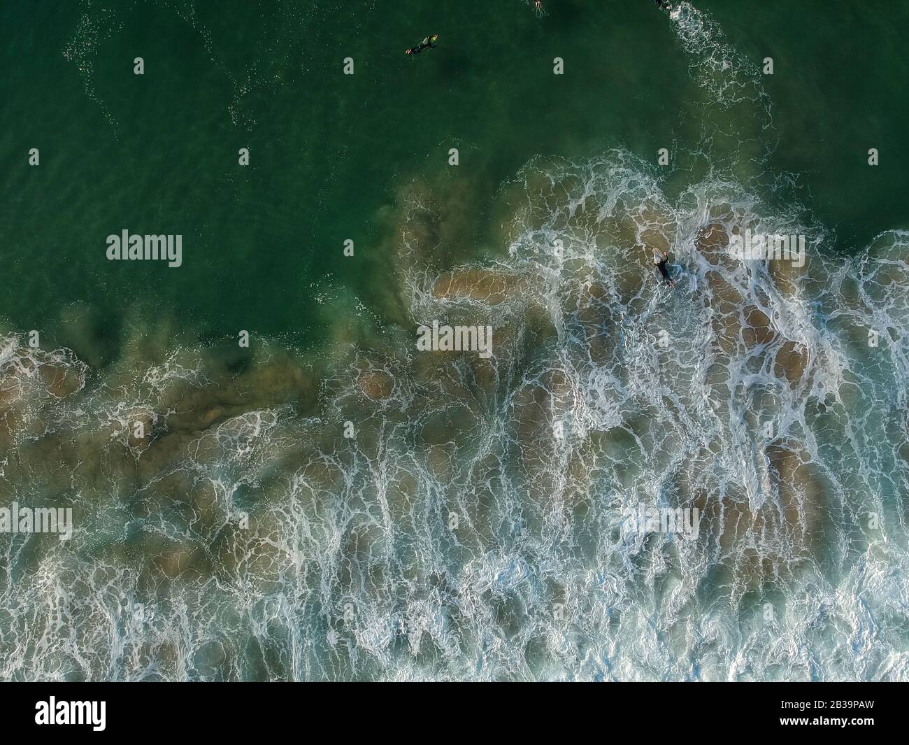 Aerial view of surfers and big wave in the ocean. Top view Stock Photo ...