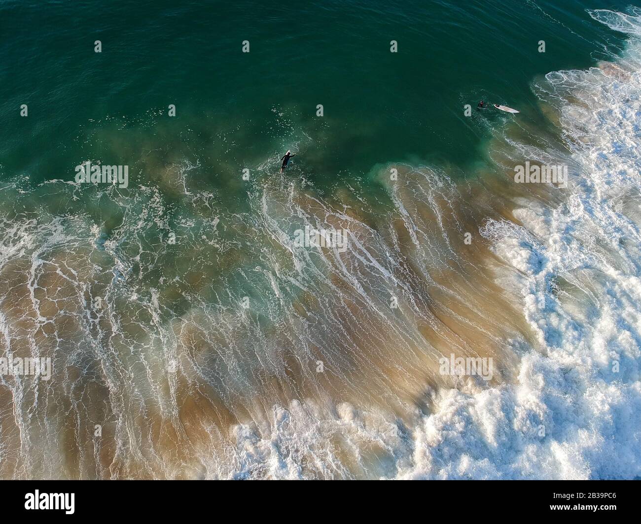 Aerial view of surfers and big wave in the ocean. Top view Stock Photo ...