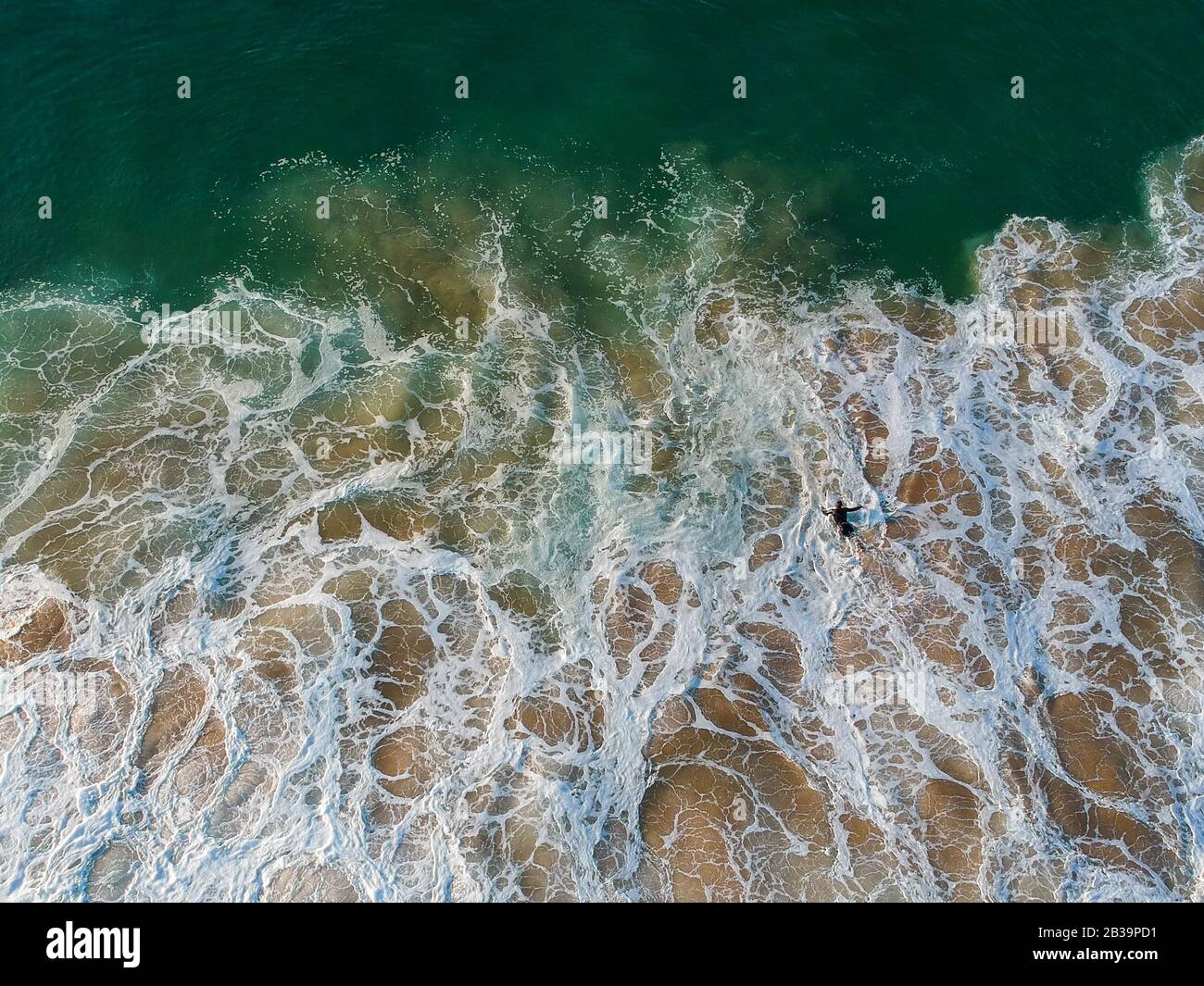 Aerial view of surfers and big wave in the ocean. Top view Stock Photo ...