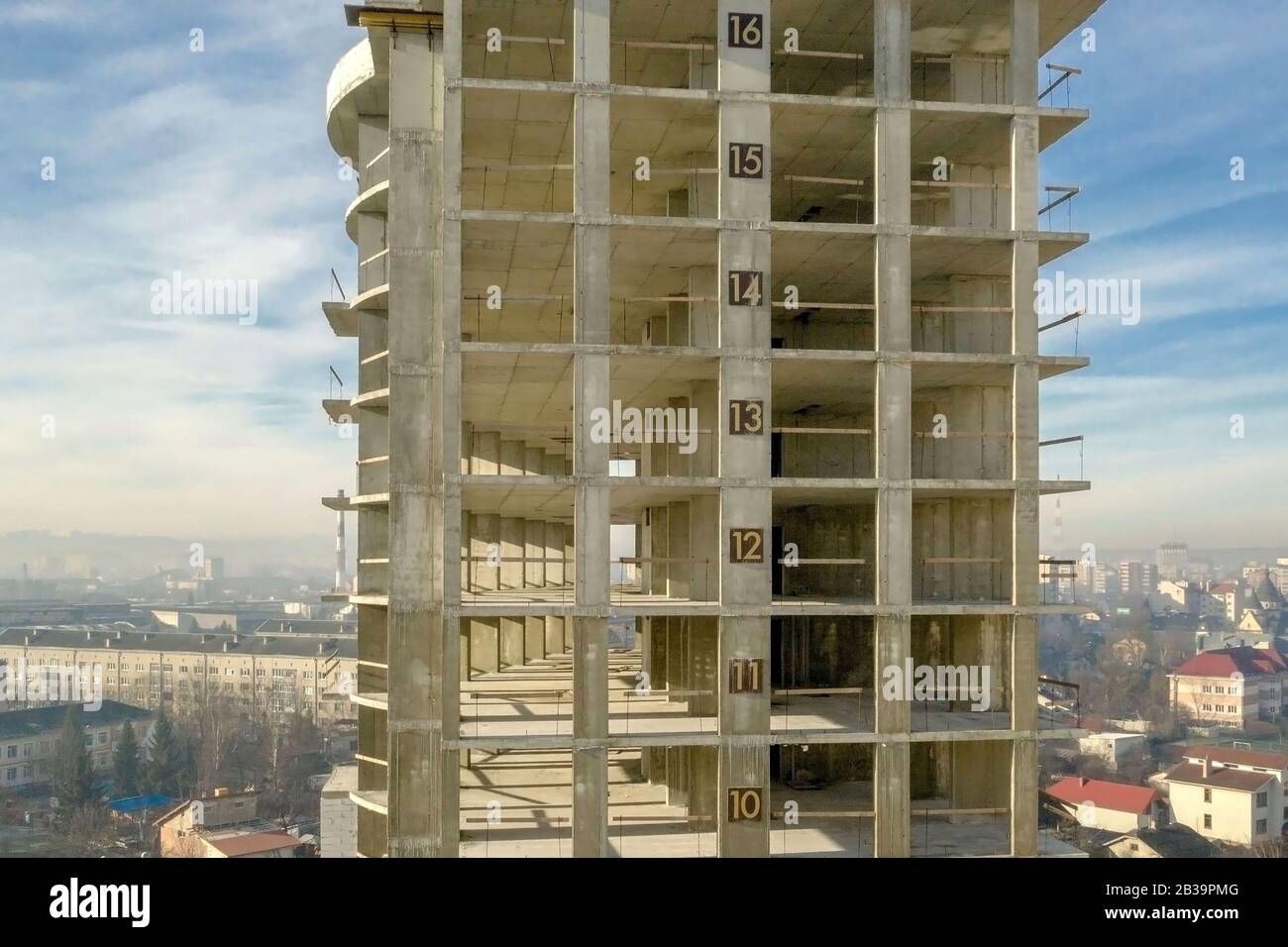 Aerial view of concrete frame of tall apartment building under ...