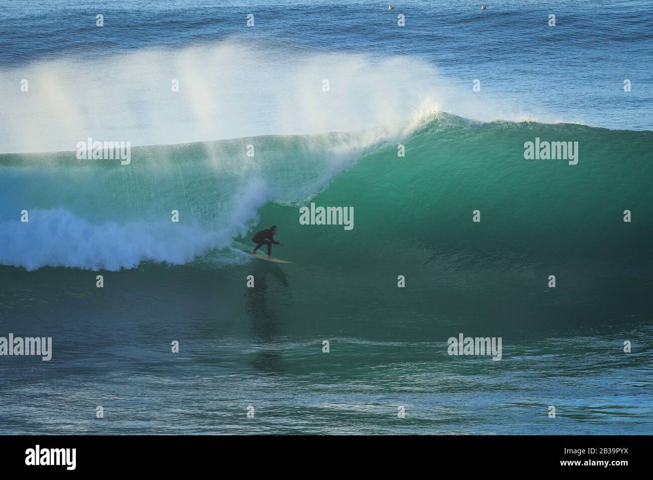 Surfer on Blue Ocean Wave . Surf spot in Ericeira Portugal Stock Photo ...