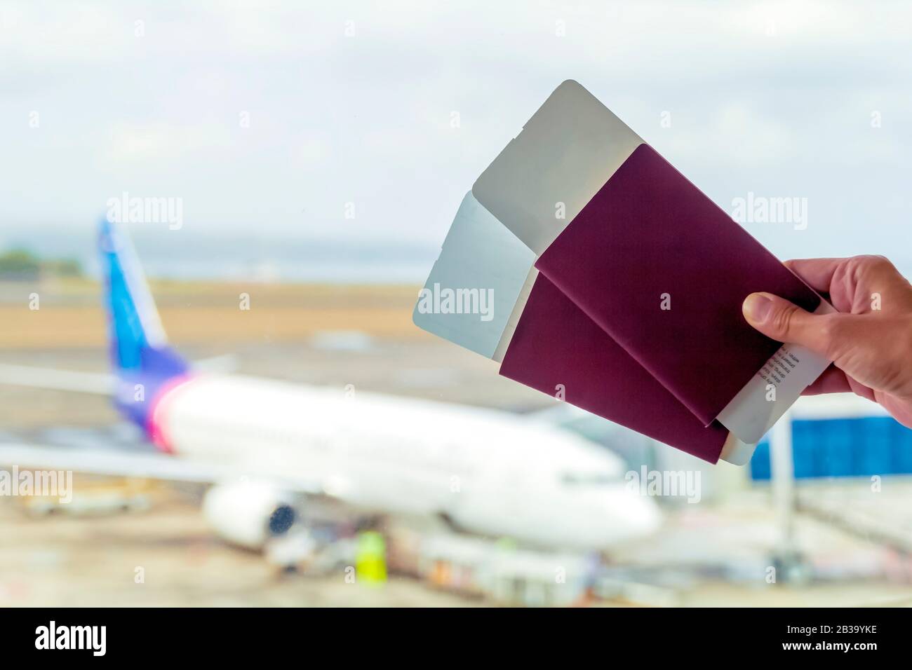 Two passports and boarding passes in a woman hand opposite the ...