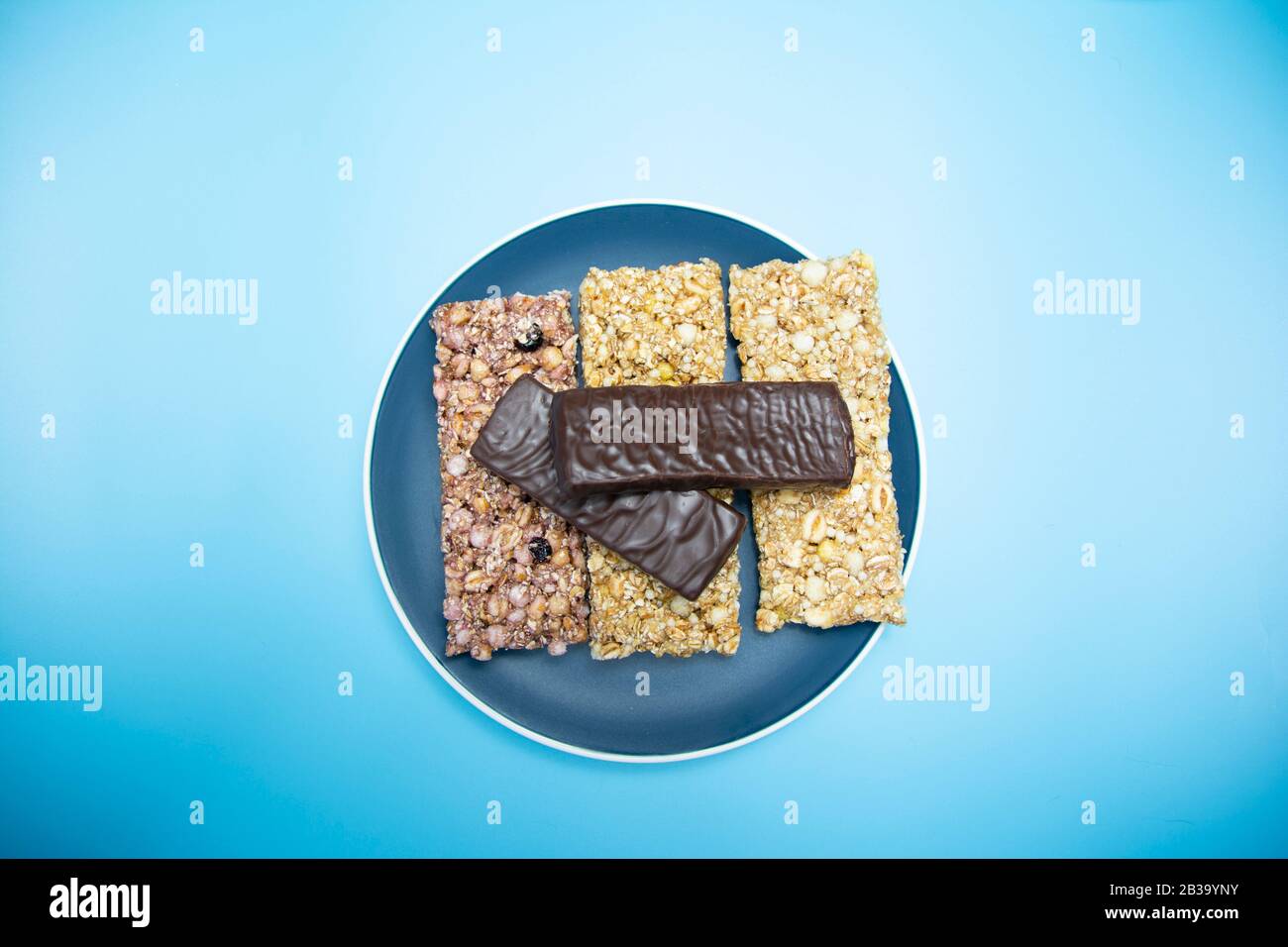 healthy nutrition protein bars on blue background Stock Photo - Alamy