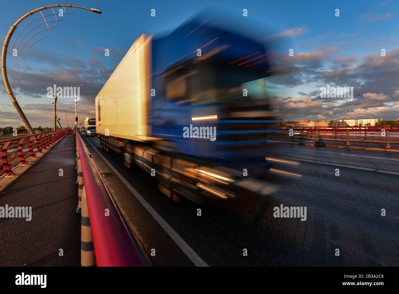 the lorry pulls over the drawbar pulling a heavy load behind it and ...