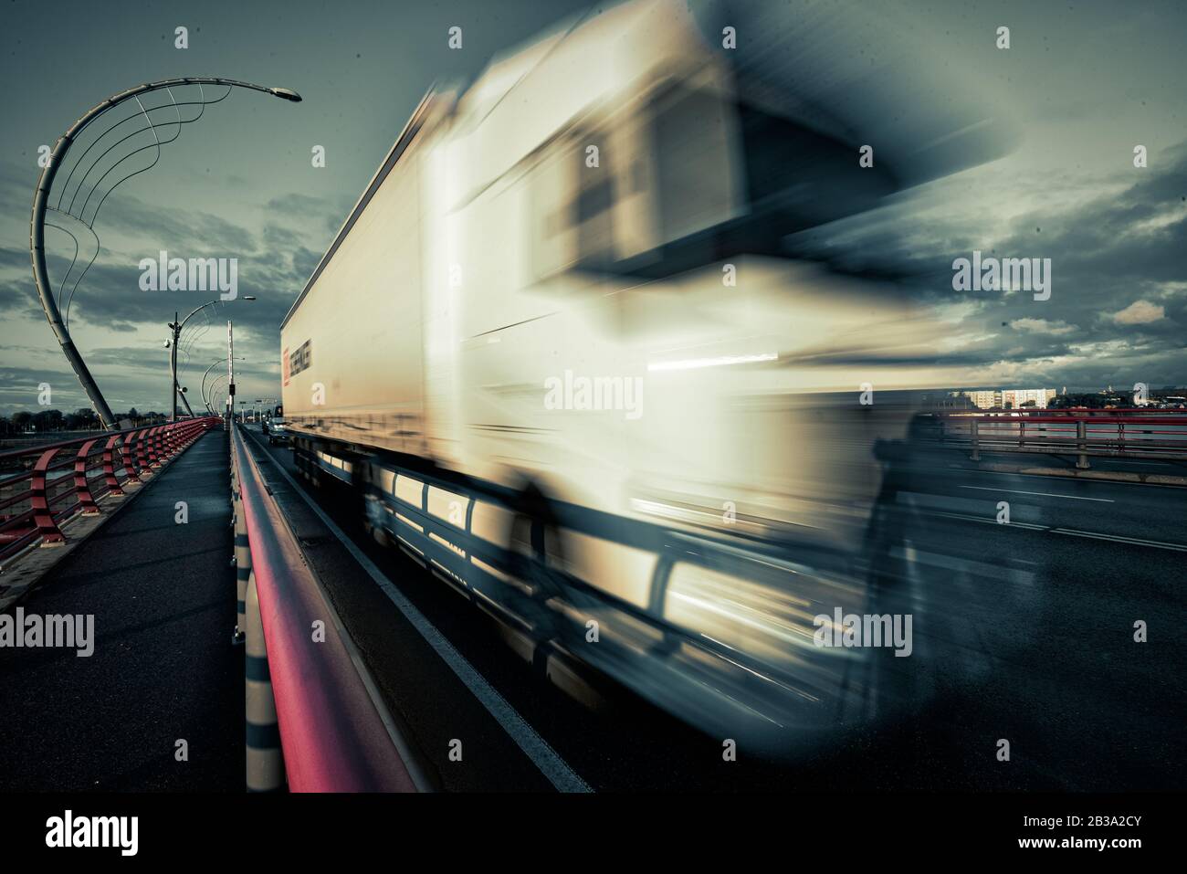 the lorry pulls over the drawbar pulling a heavy load behind it and ...